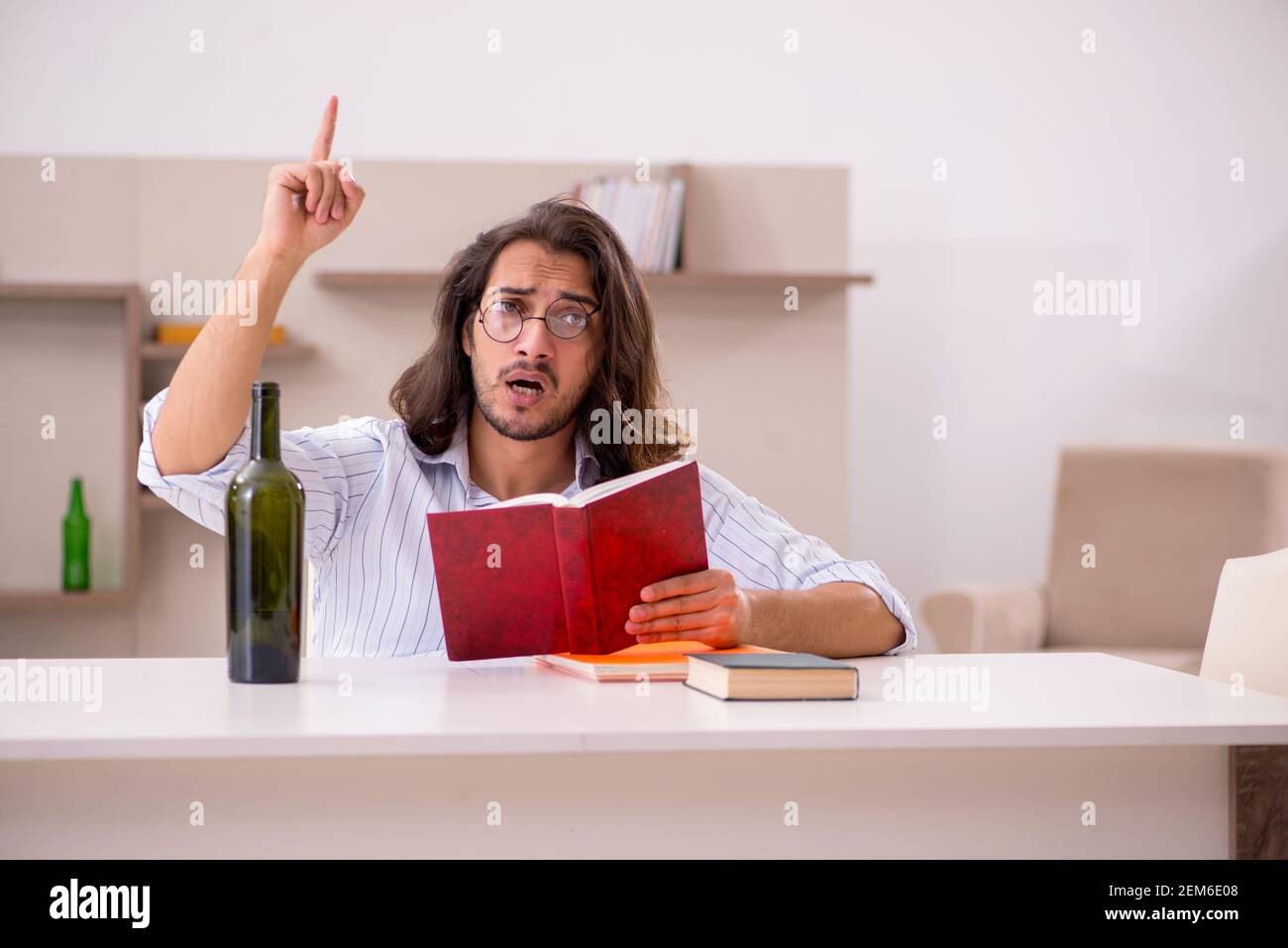 Male student drinking alcohol at home Stock Photo - Alamy