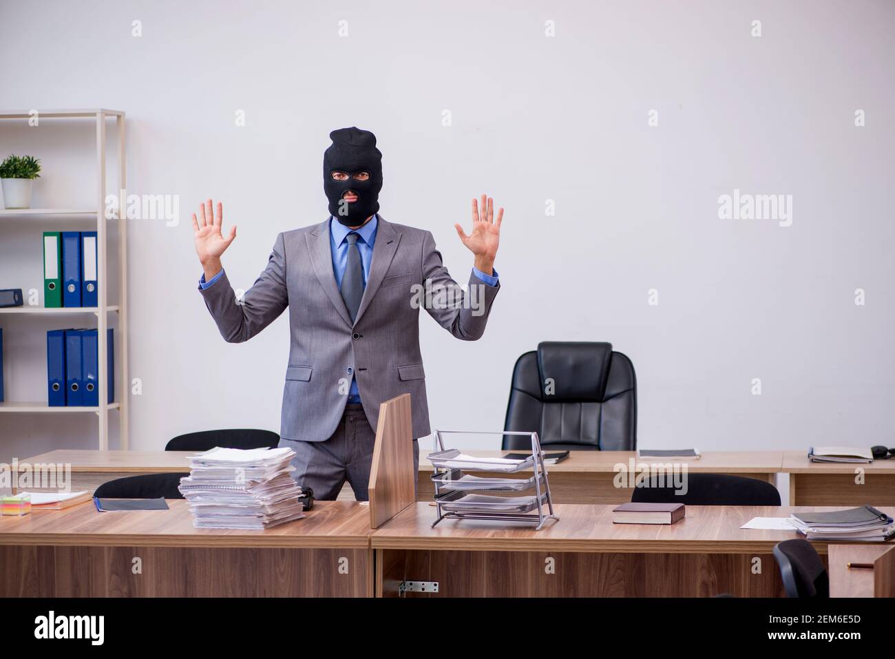 Young employee in industrial espionage concept Stock Photo - Alamy