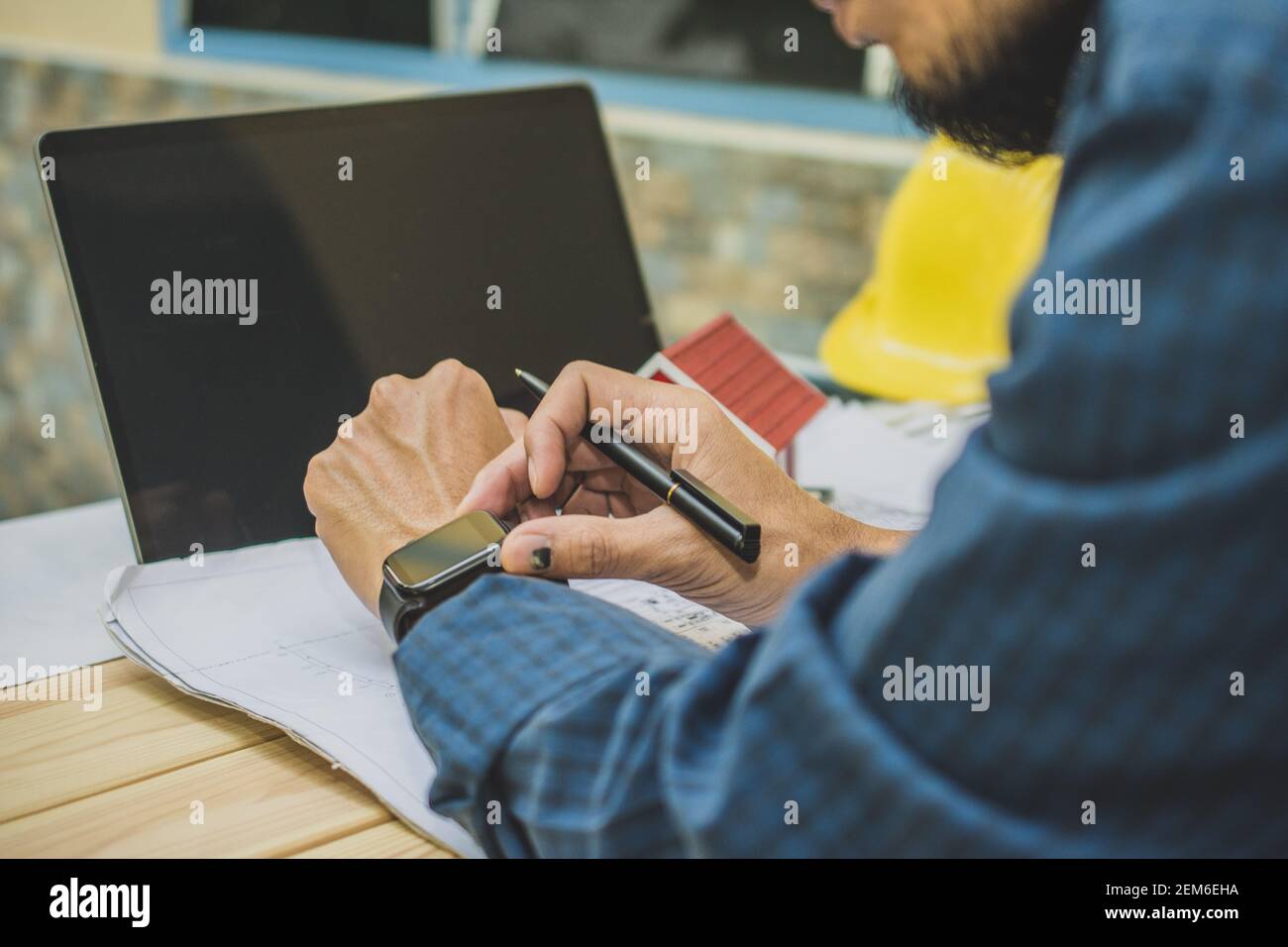 Worker working in office with laptop computer and work house design for ...