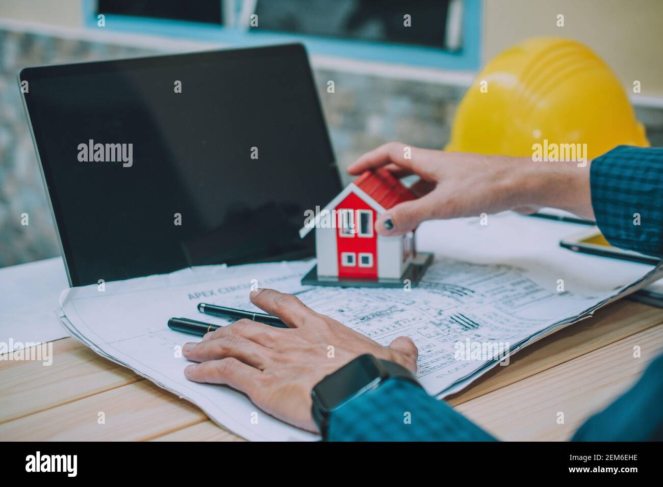 Worker working in office with laptop computer and work house design for ...