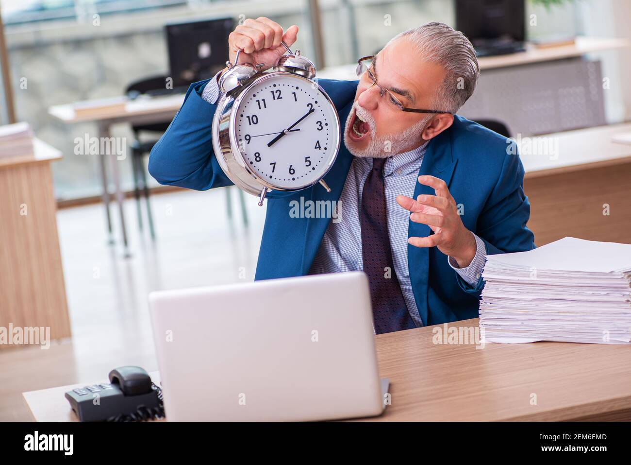 Old boss employee in time management concept Stock Photo - Alamy