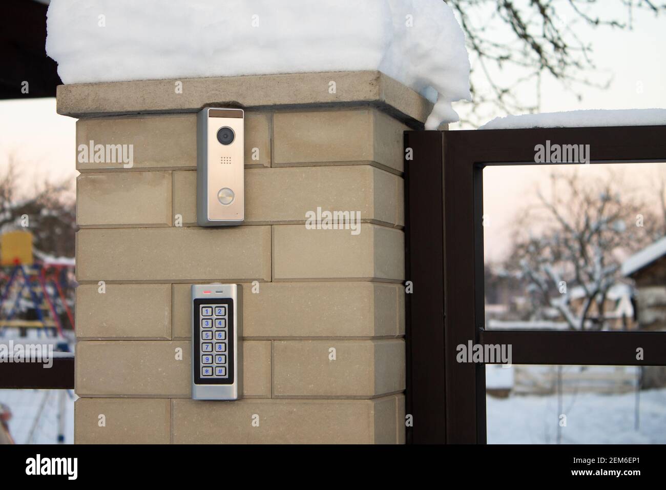 Silver intercom call panel with blue number buttons and a video camera ...