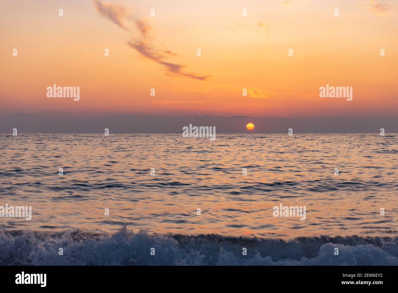 Yellow sunset from the low sun. Seashore with a sunset path on the ...