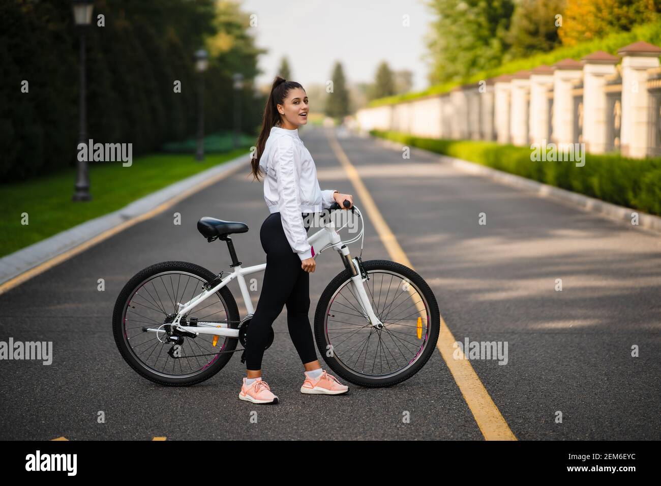 Beautiful girl posing at white bicycle. Walk in nature Stock Photo - Alamy