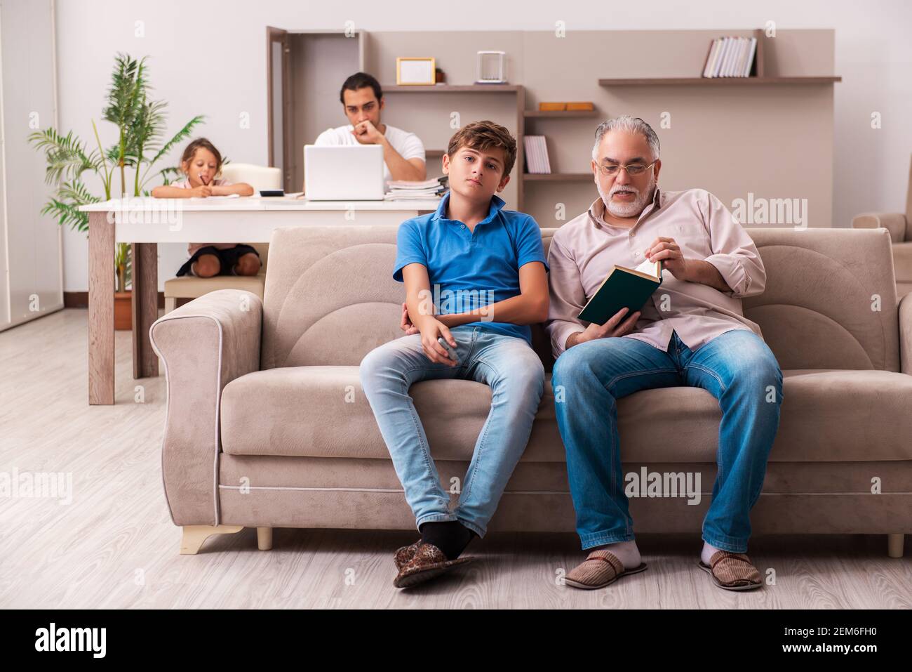 Three generations at home in early development concept Stock Photo - Alamy