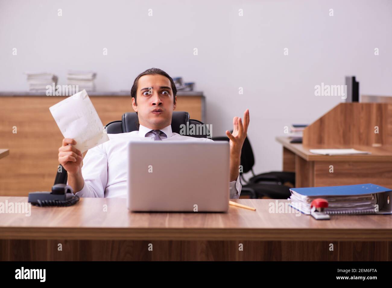 Young businessman employee unhappy with office prank in the office ...