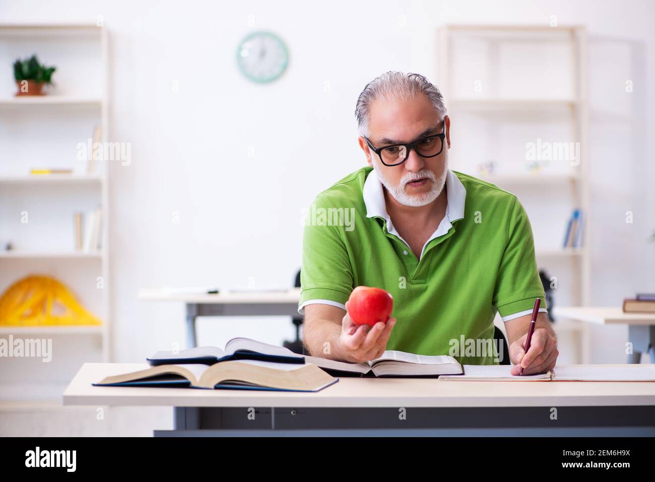 Male teacher eating apple hi-res stock photography and images - Alamy