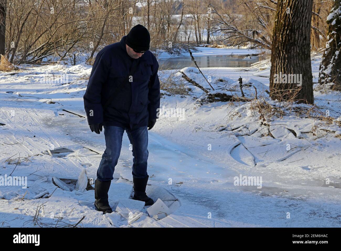 A man broke into the ice in winter. Dangerous thin ice Stock Photo - Alamy