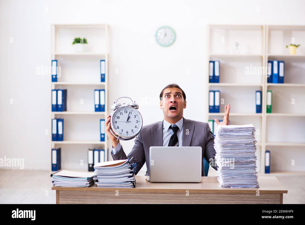 Workload employee in time management concept Stock Photo - Alamy
