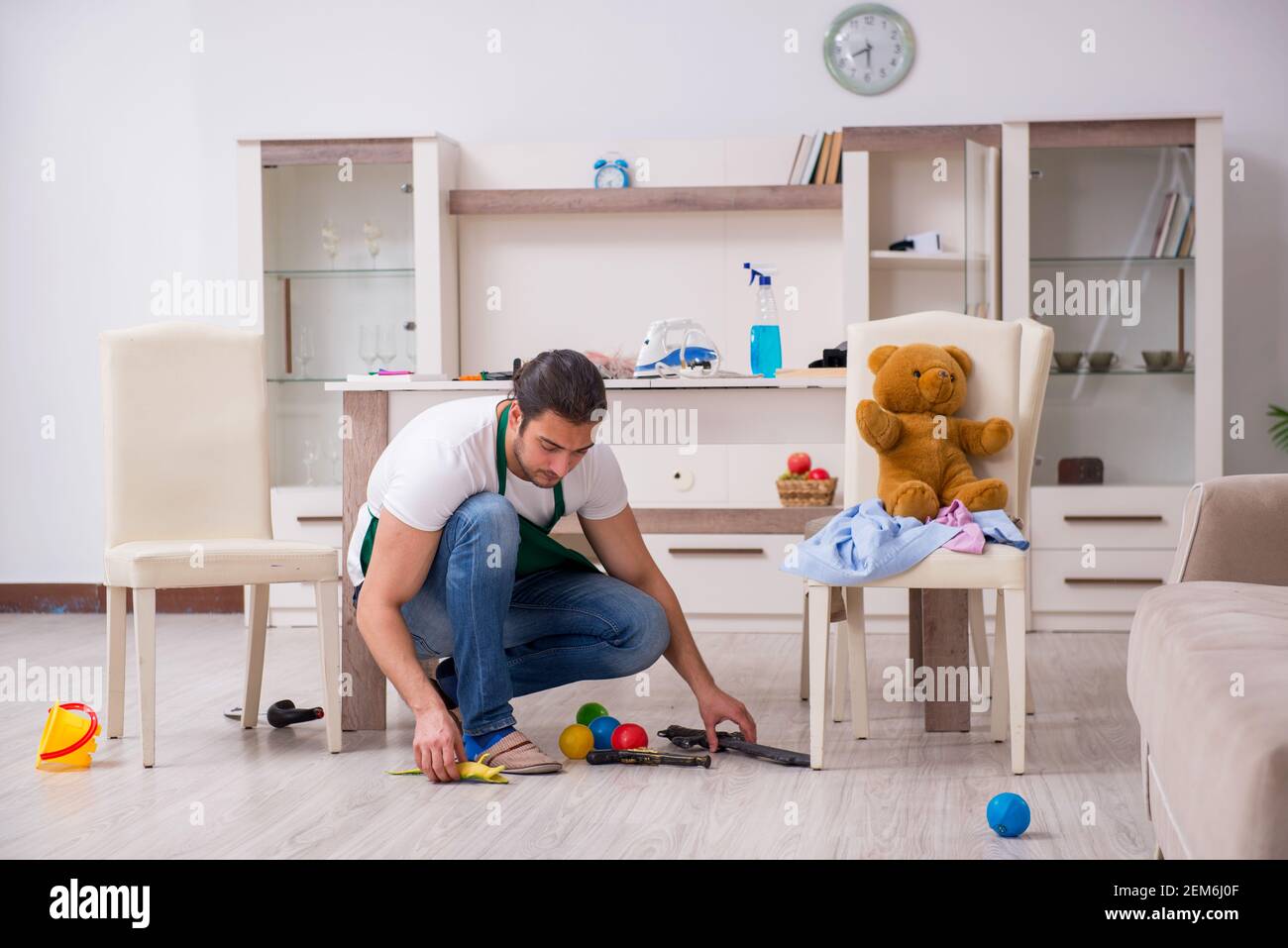 Young contractor cleaning the flat after kids' party Stock Photo - Alamy