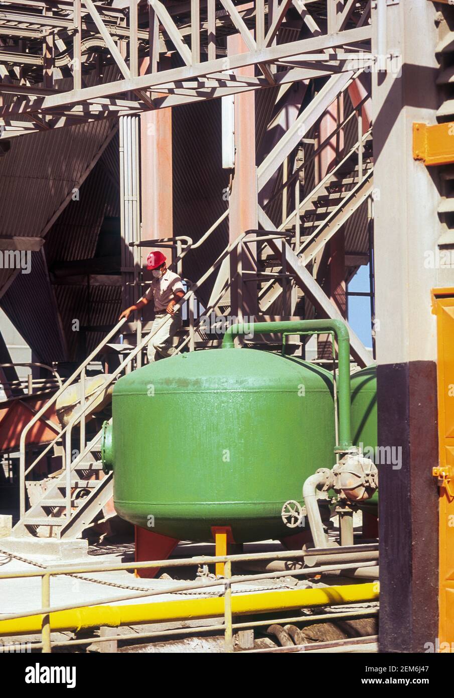 Worker walking on staircase at cement factory, Venezuela Stock Photo ...