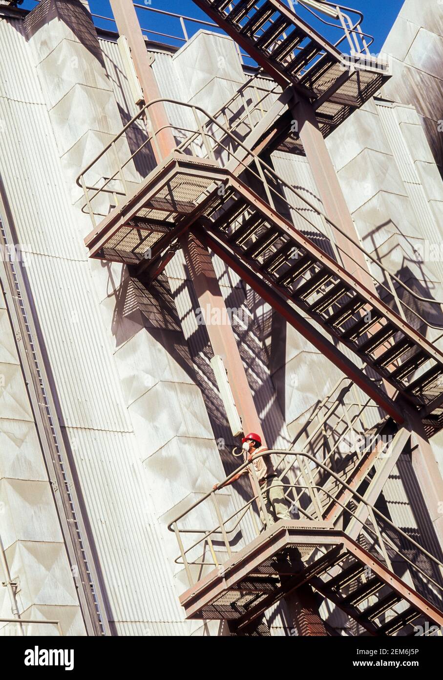 EWorker standing on staircase at cement factory, Venezuela Stock Photo ...