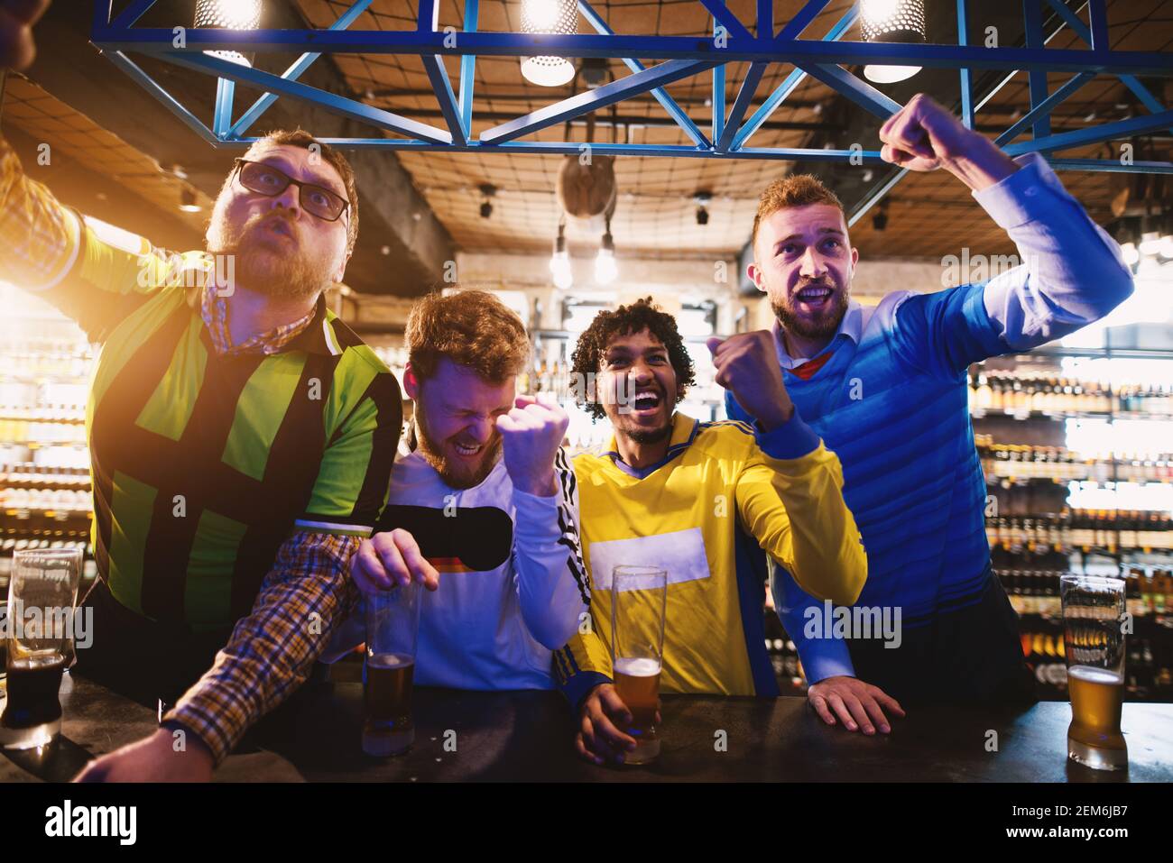 Soccer fans are drinking beer and celebrating the score of their ...