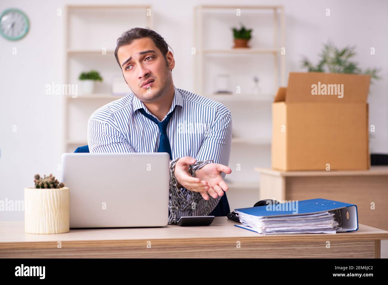 Chained employee working in hi-res stock photography and images - Alamy