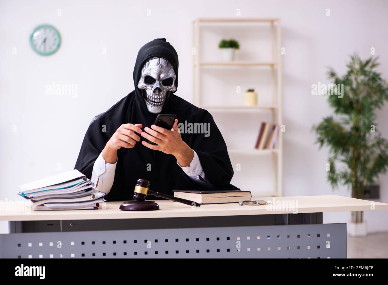 Devil judge working in the courthouse Stock Photo - Alamy