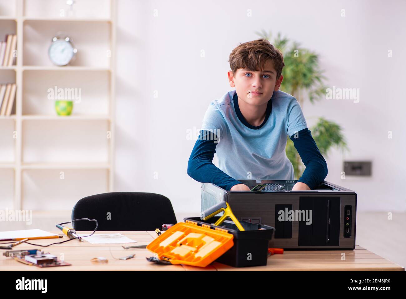 Teenager reparing computers at workshop Stock Photo - Alamy