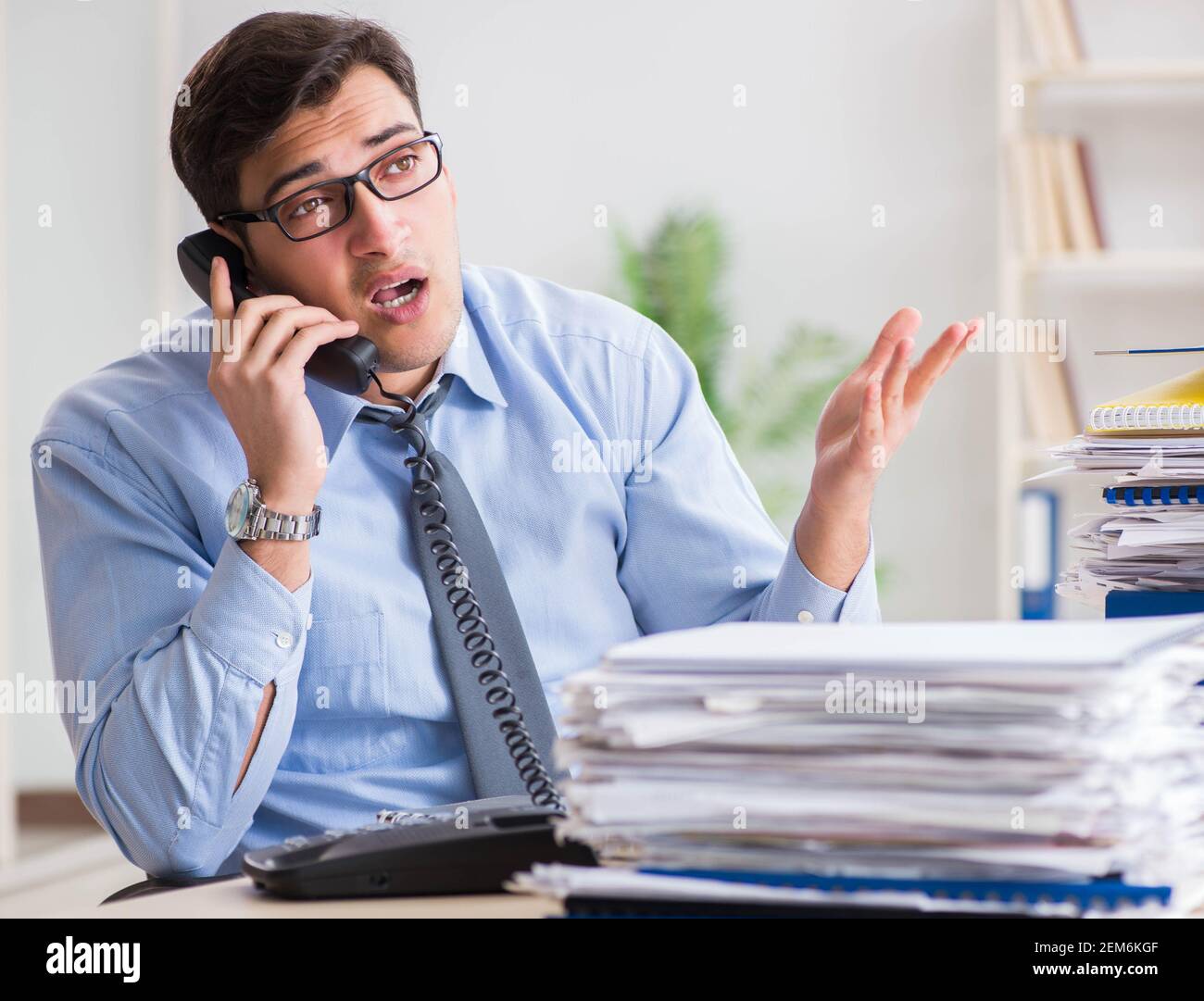 The extremely busy businessman working in office Stock Photo - Alamy