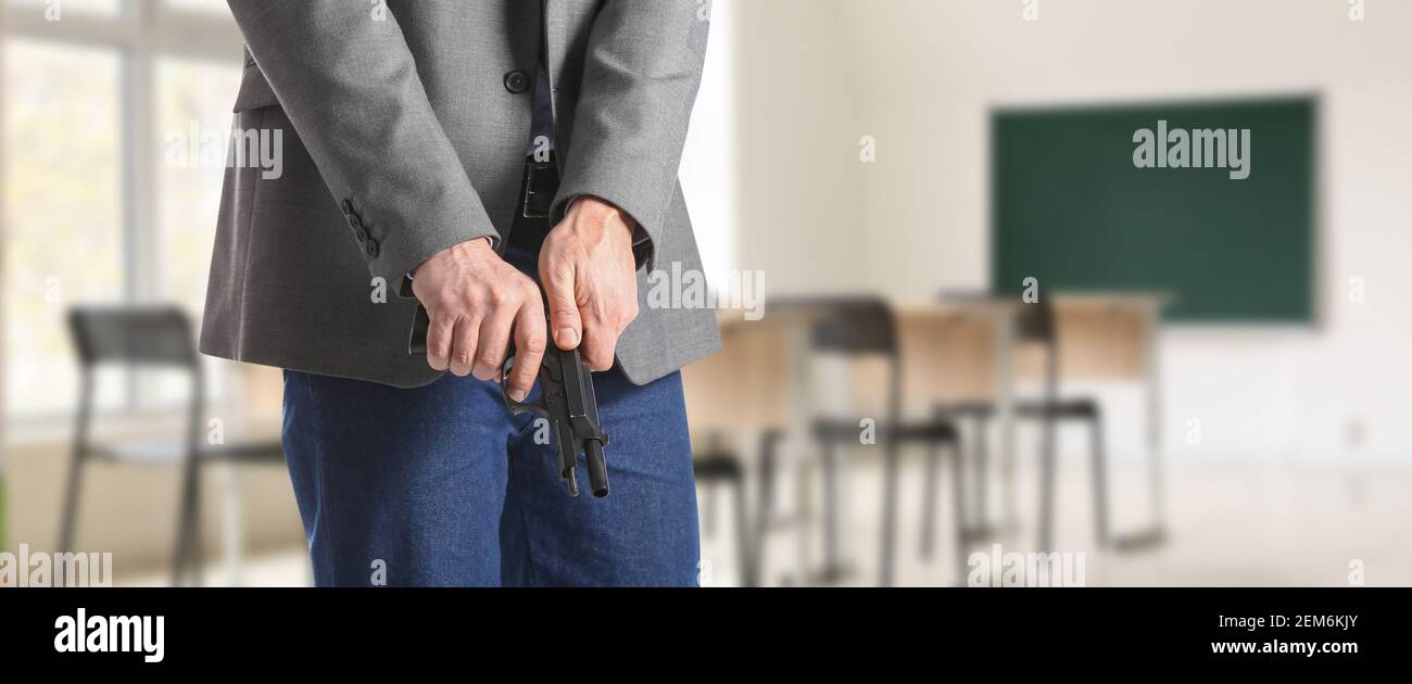 Man with pistol in classroom. No guns in school Stock Photo - Alamy