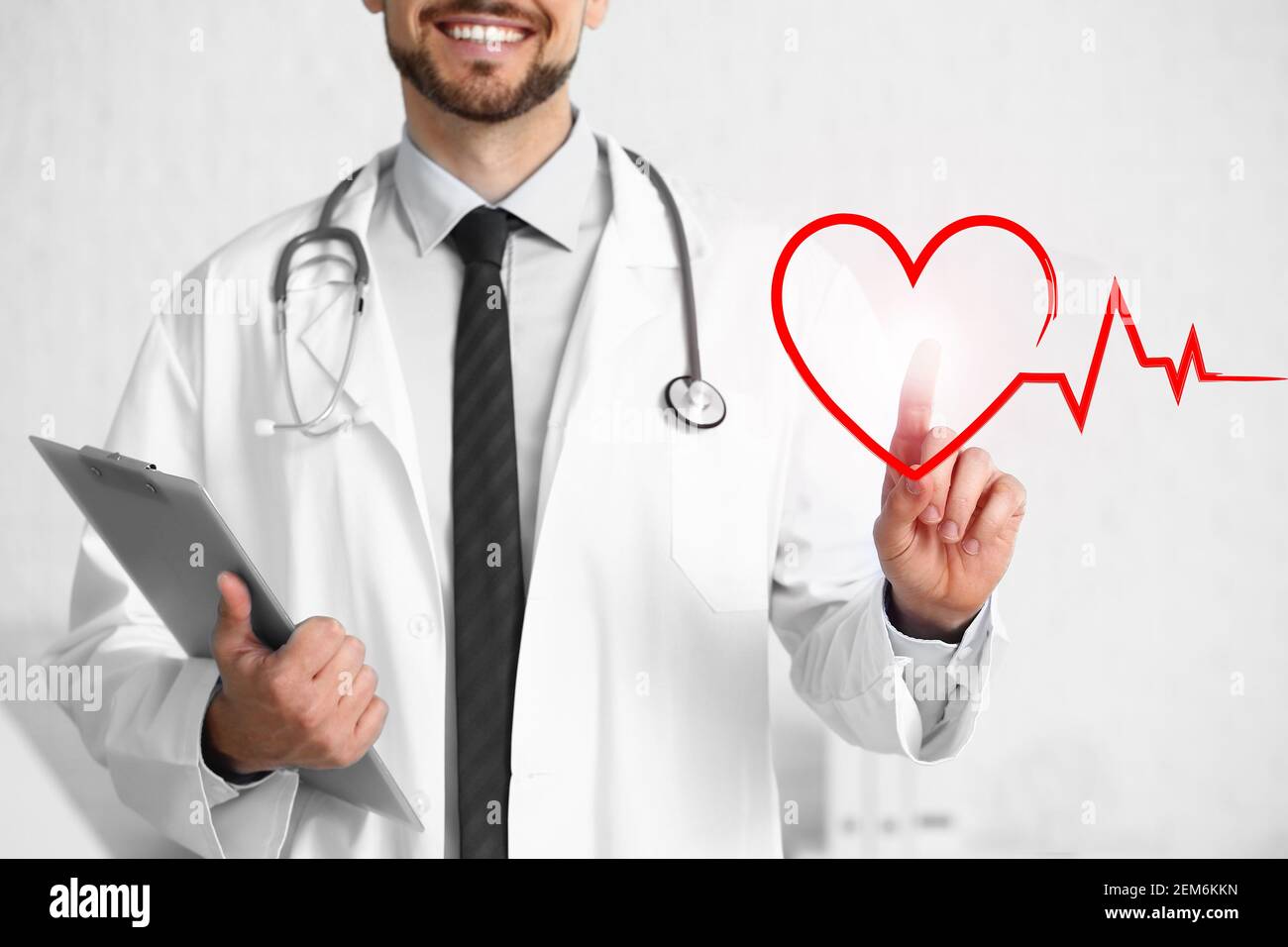 Mature cardiologist, drawn heart and cardiogram on light background ...