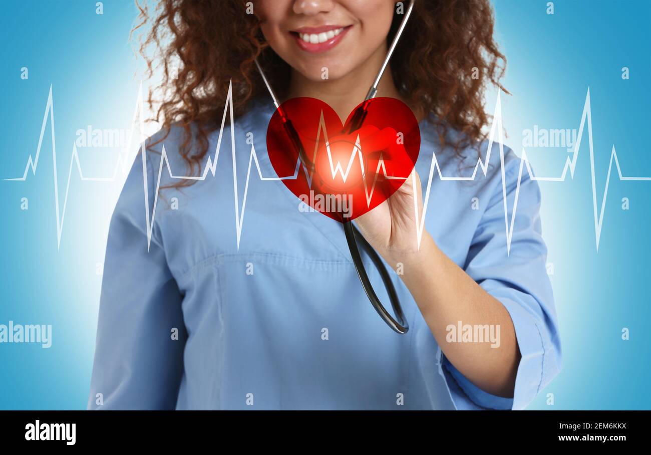 African-American cardiologist with stethoscope using virtual screen on ...