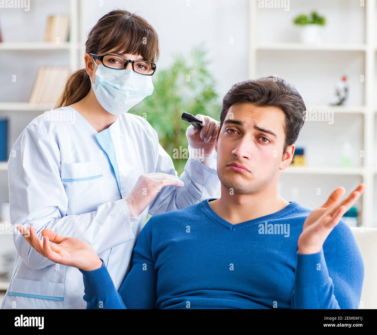 The doctor checking patients ear during medical examination Stock Photo ...