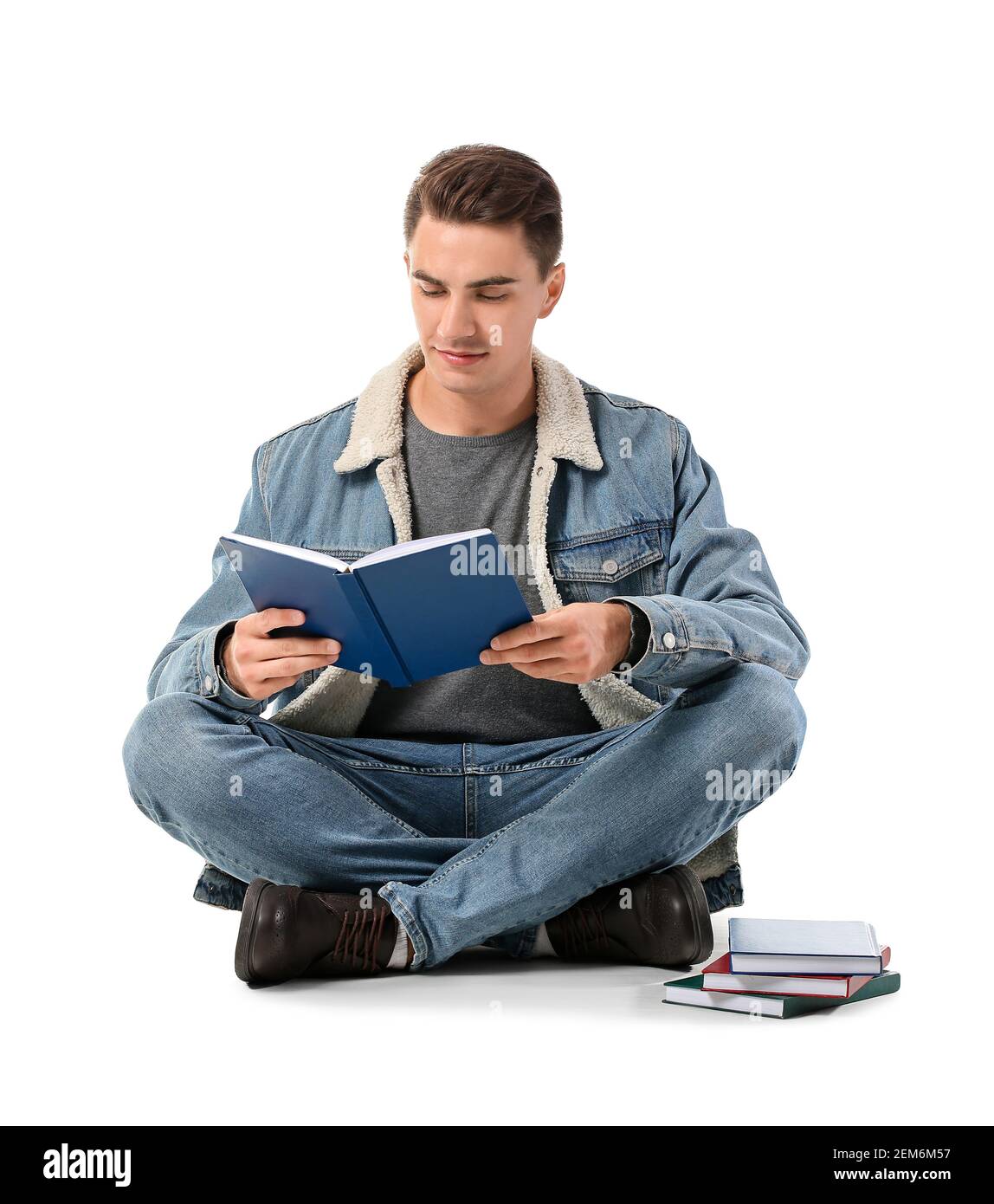 Young man reading books on white background Stock Photo - Alamy