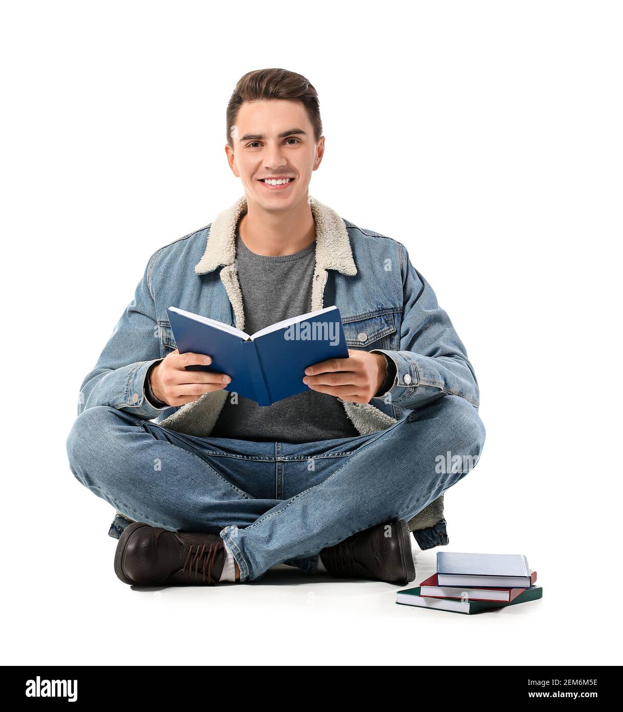 Young man reading books on white background Stock Photo - Alamy