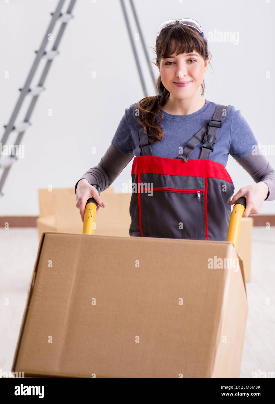 The woman contractor moving boxes in relocation concept Stock Photo - Alamy