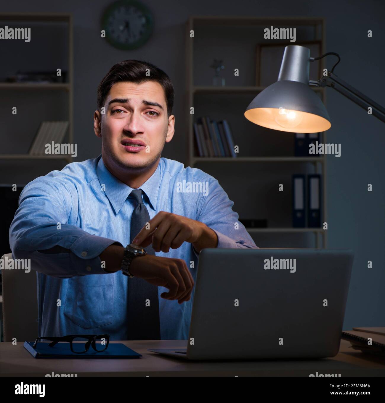 The employee working late at night at important report Stock Photo - Alamy