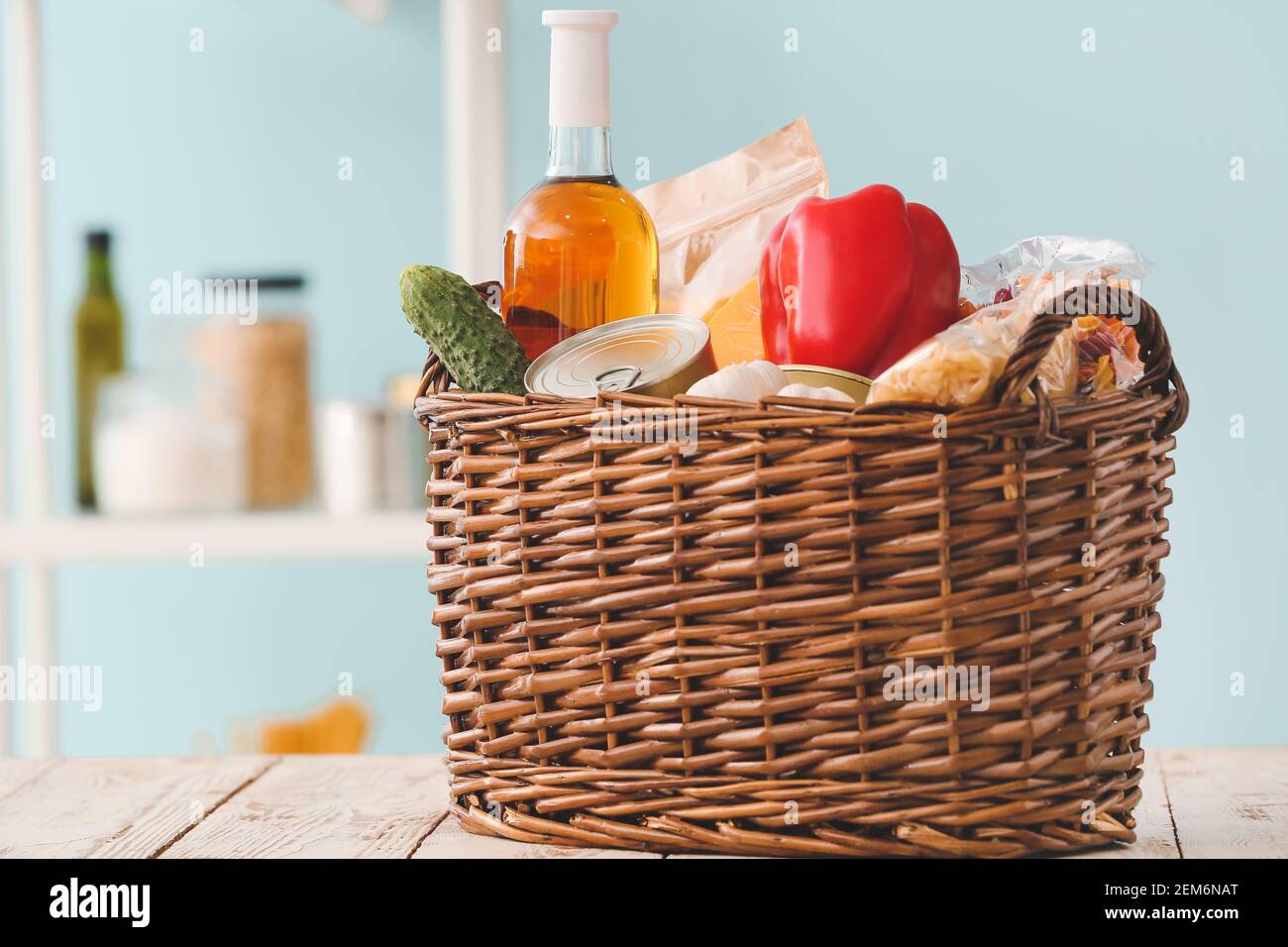 Basket with different products on table in kitchen Stock Photo - Alamy