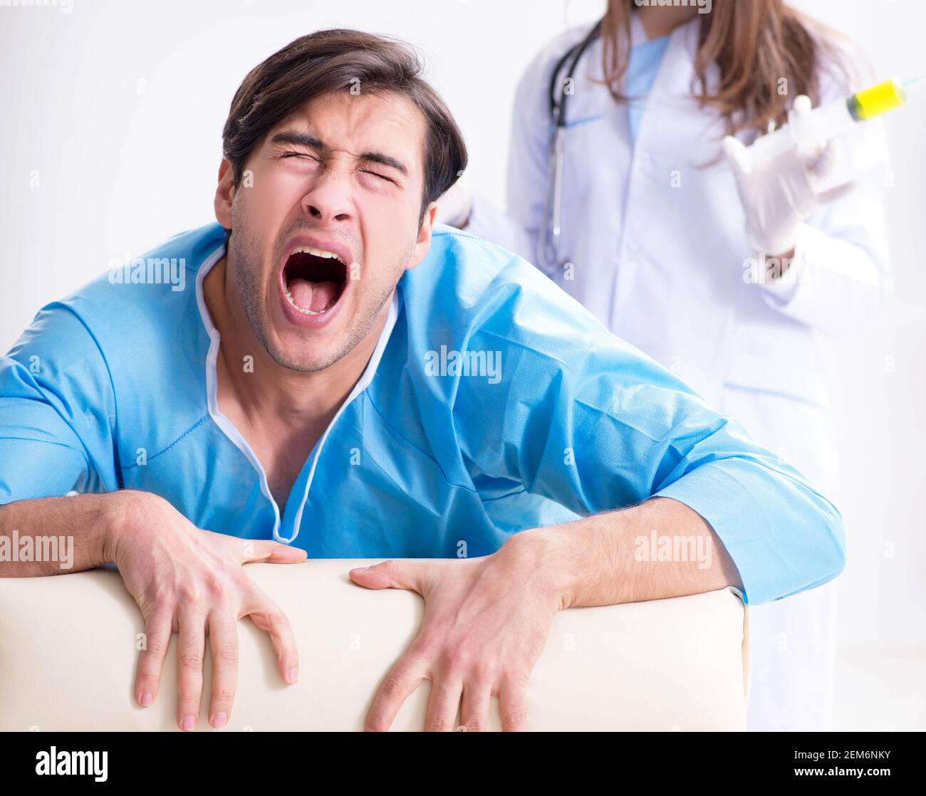 The funny man getting ready for buttocks syringe shot Stock Photo - Alamy