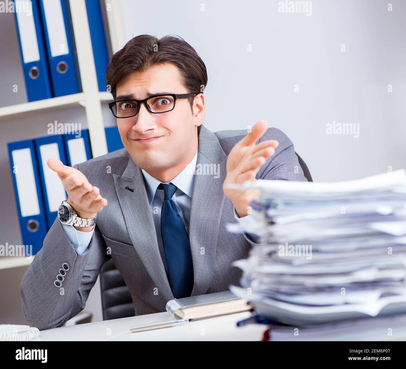 The businessman workaholic struggling with pile of paperwork Stock ...