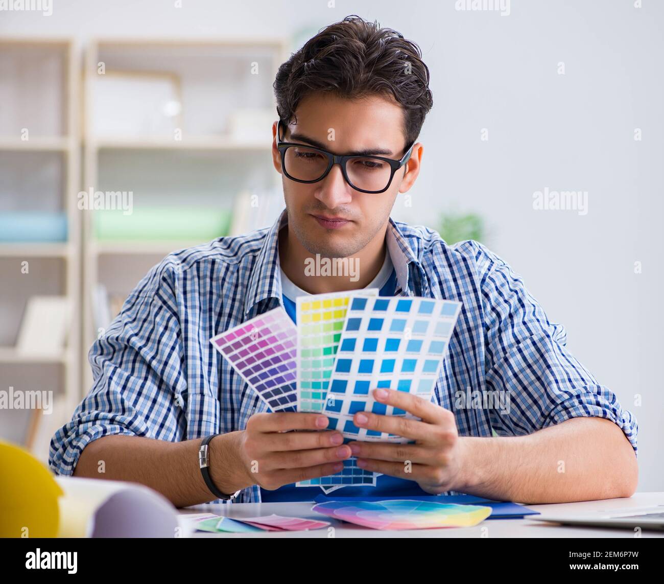 The young designer working on new project and choosing colours Stock ...