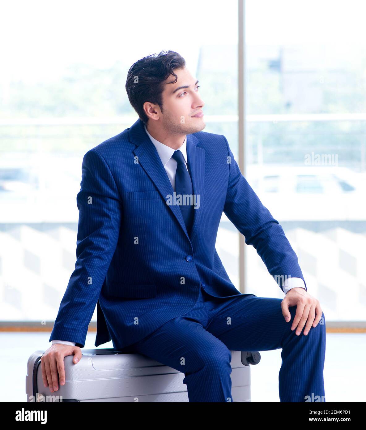 The businessman waiting for his flight at airport Stock Photo - Alamy