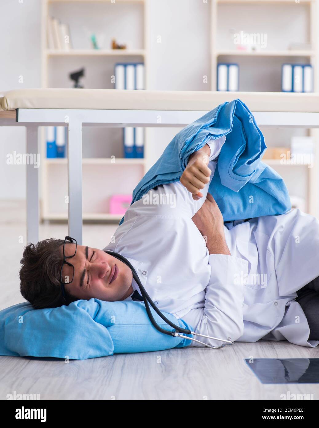 The doctor sleeping on floor after long night shift Stock Photo - Alamy