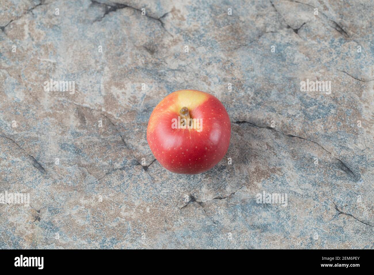 Red apple on a grey stone background Stock Photo - Alamy
