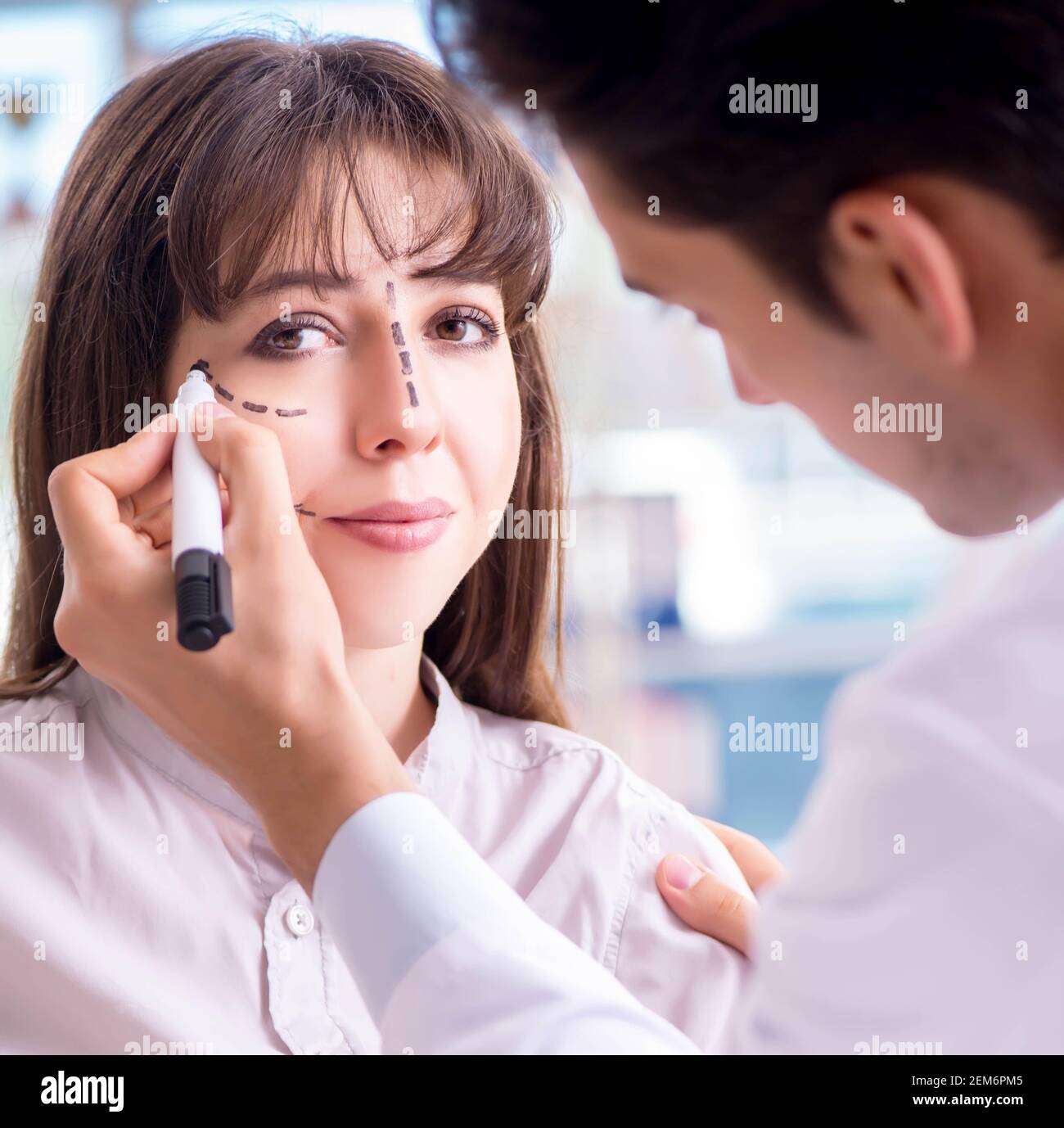 The plastic surgeon preparing for operation on woman face Stock Photo ...