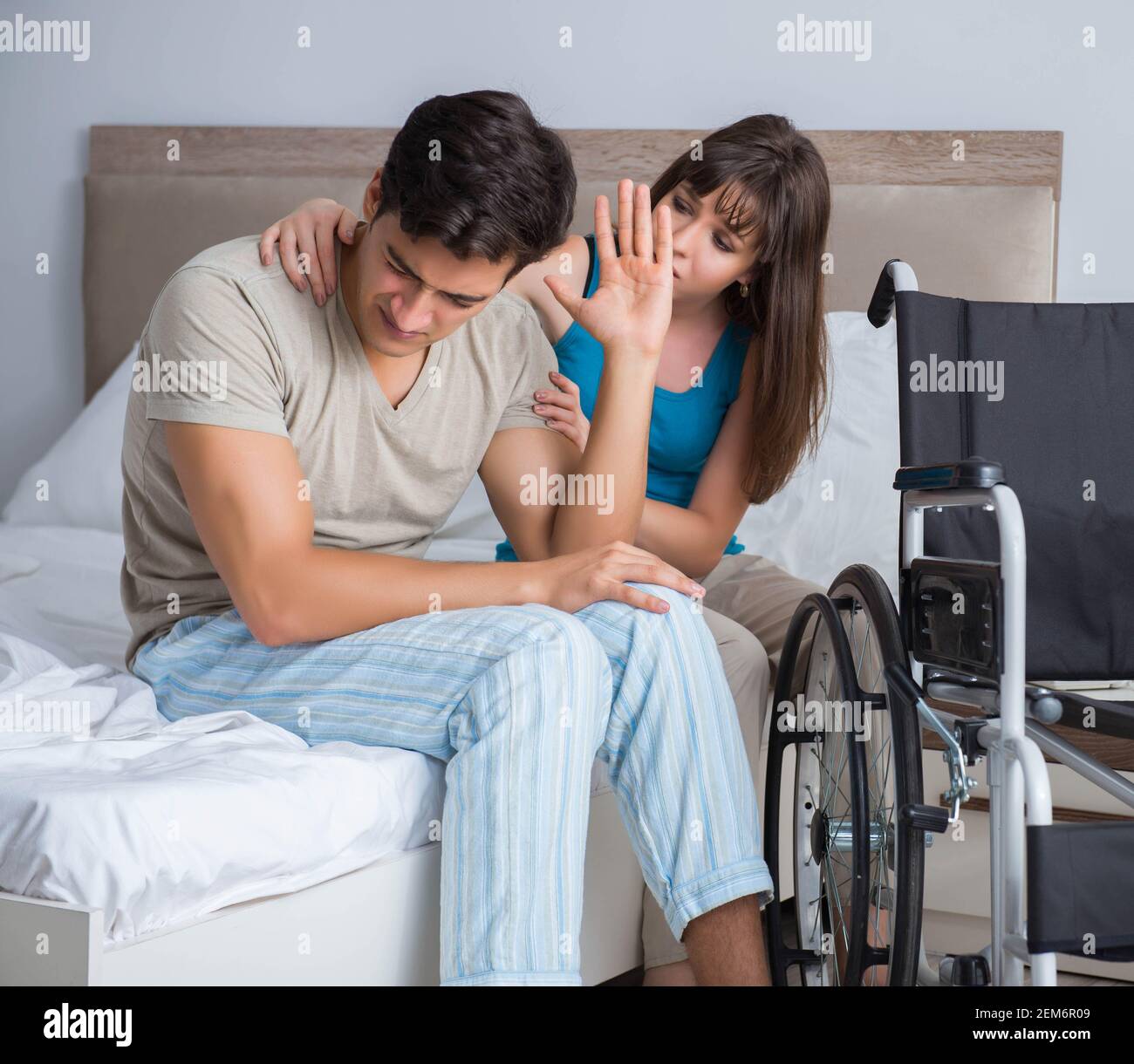 The desperate man on wheelchair with his sad wife Stock Photo - Alamy