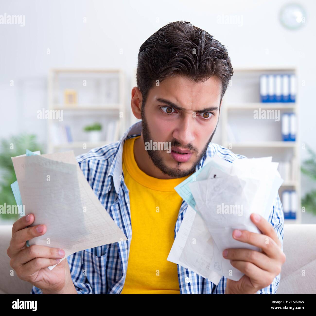 The man angry at bills he needs to pay Stock Photo - Alamy