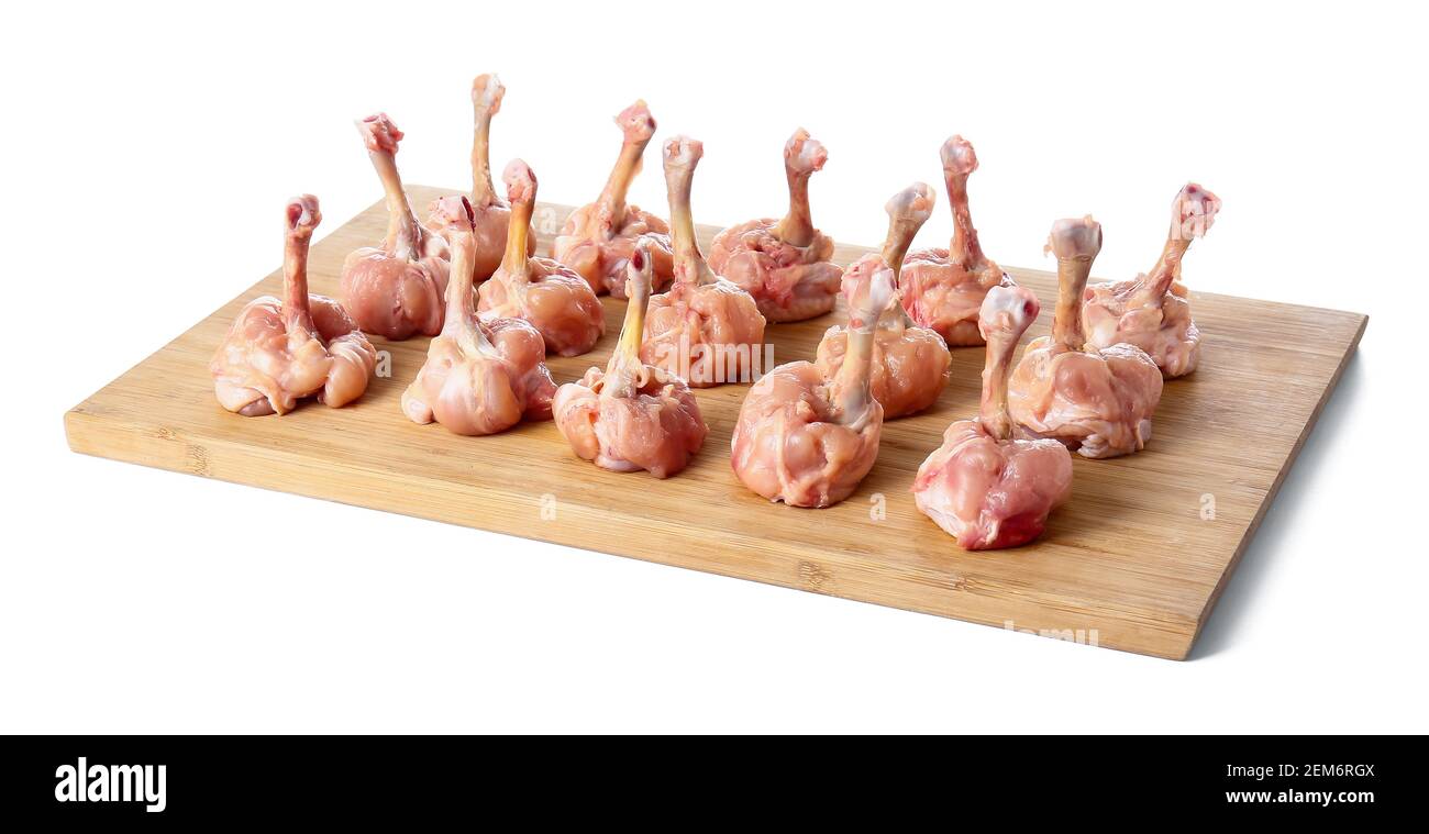 Board with raw chicken lollipops on white background Stock Photo - Alamy
