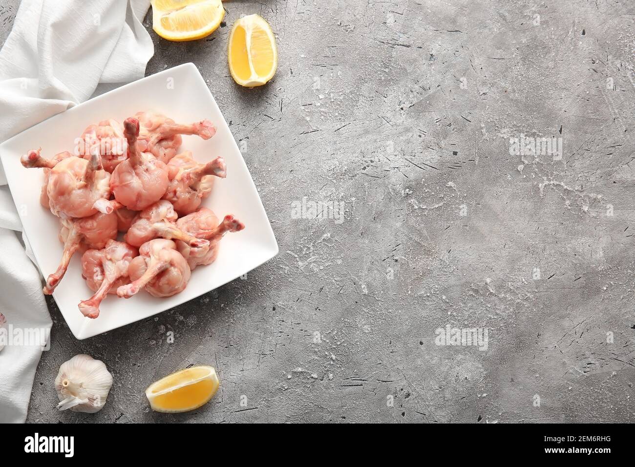 Plate with raw chicken lollipops on grey background Stock Photo - Alamy