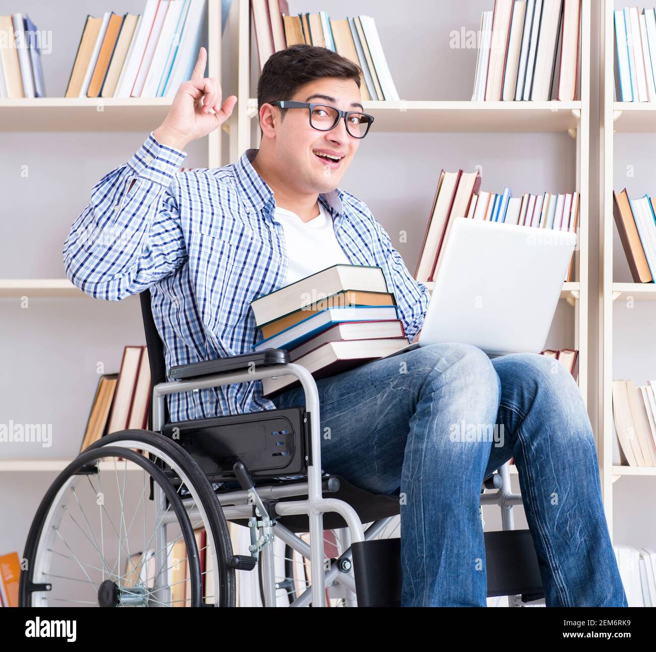 The disabled student studying in the library Stock Photo - Alamy
