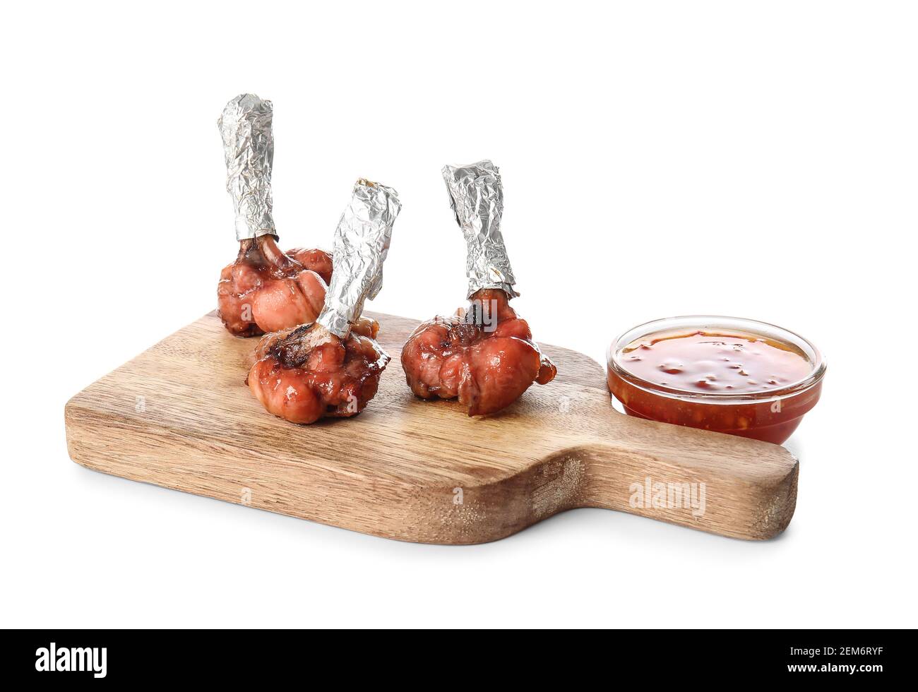 Board with tasty chicken lollipops and sauce on white background Stock ...
