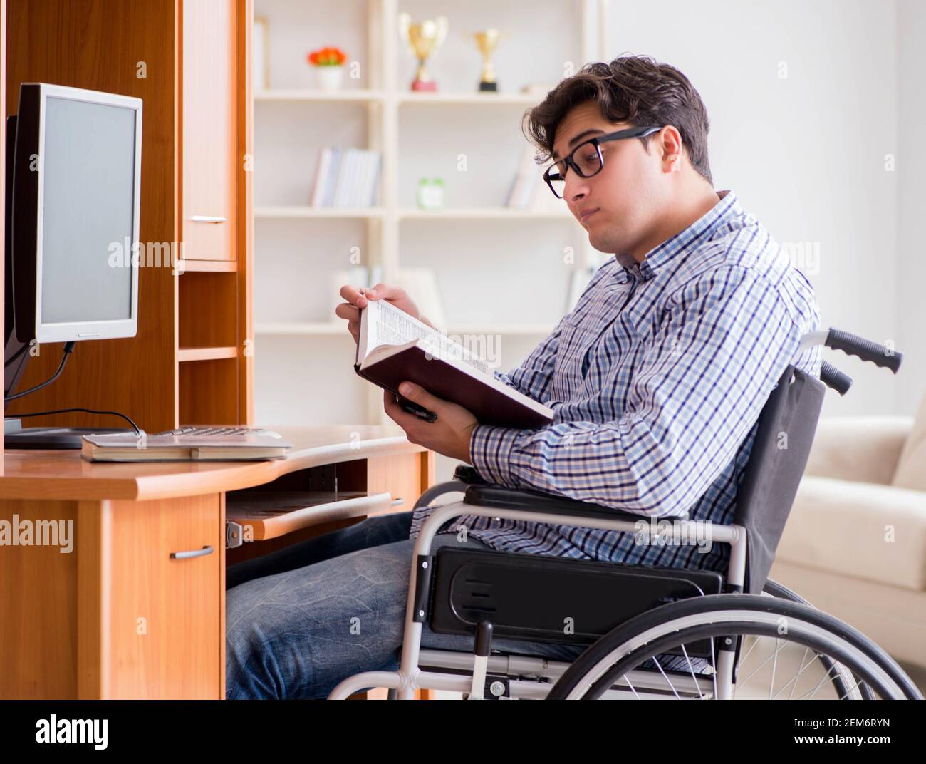 The disabled student studying at home on wheelchair Stock Photo - Alamy