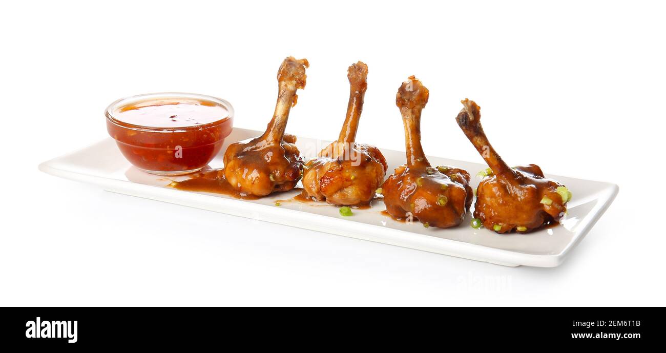 Plate with tasty chicken lollipops on white background Stock Photo - Alamy