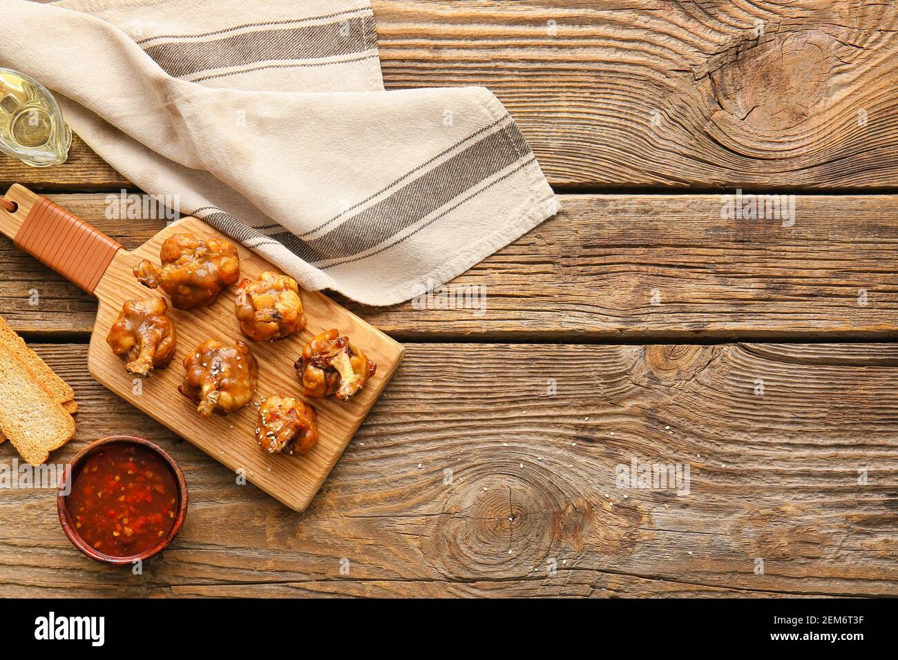 Board with tasty chicken lollipops on wooden background Stock Photo - Alamy