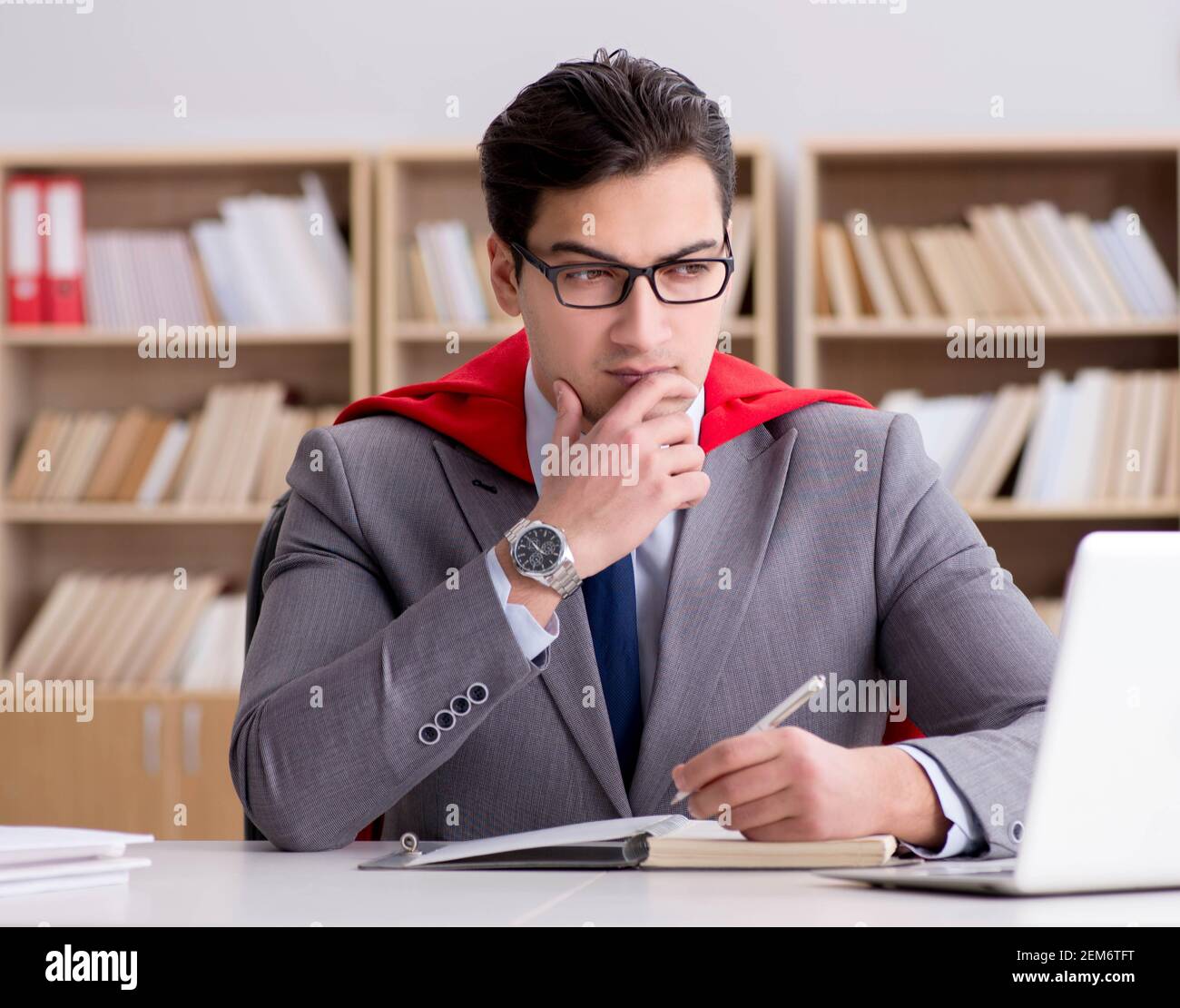 The superhero businessman working in the office Stock Photo - Alamy
