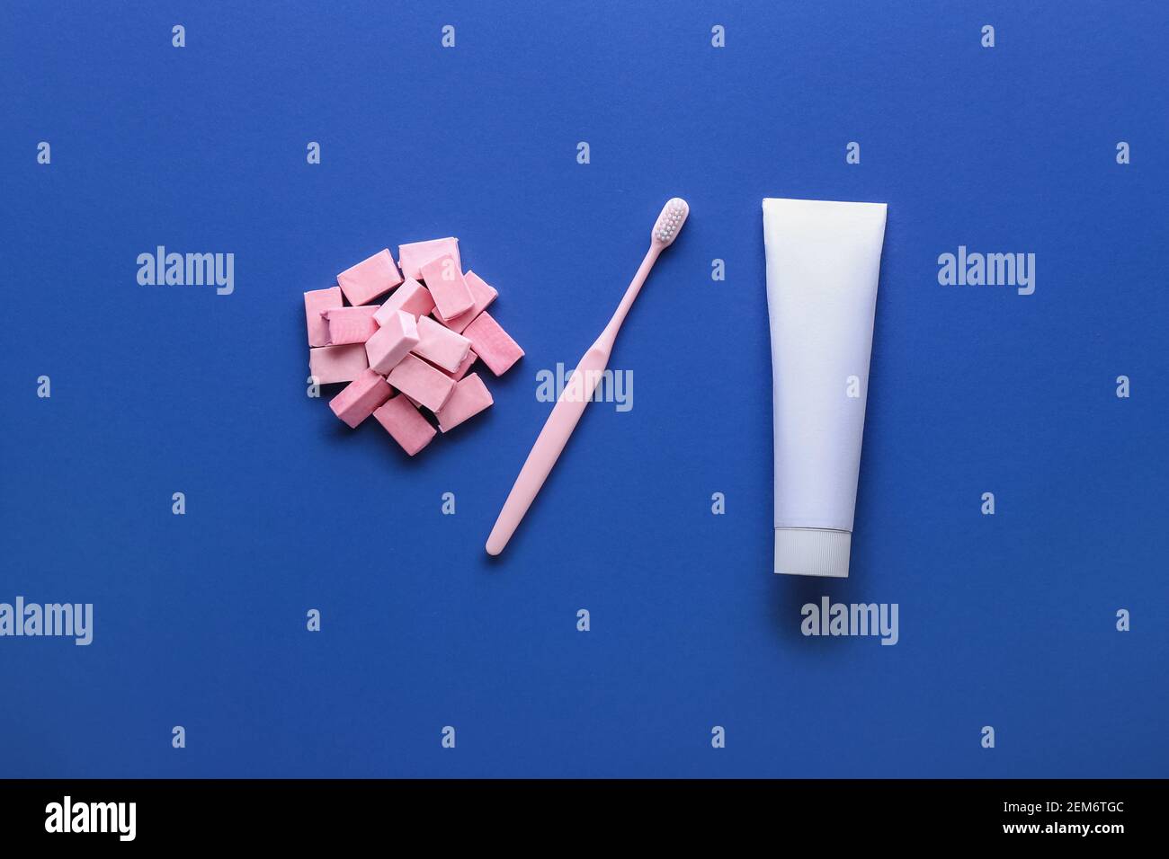 Chewing gums, toothbrush and paste on color background Stock Photo - Alamy