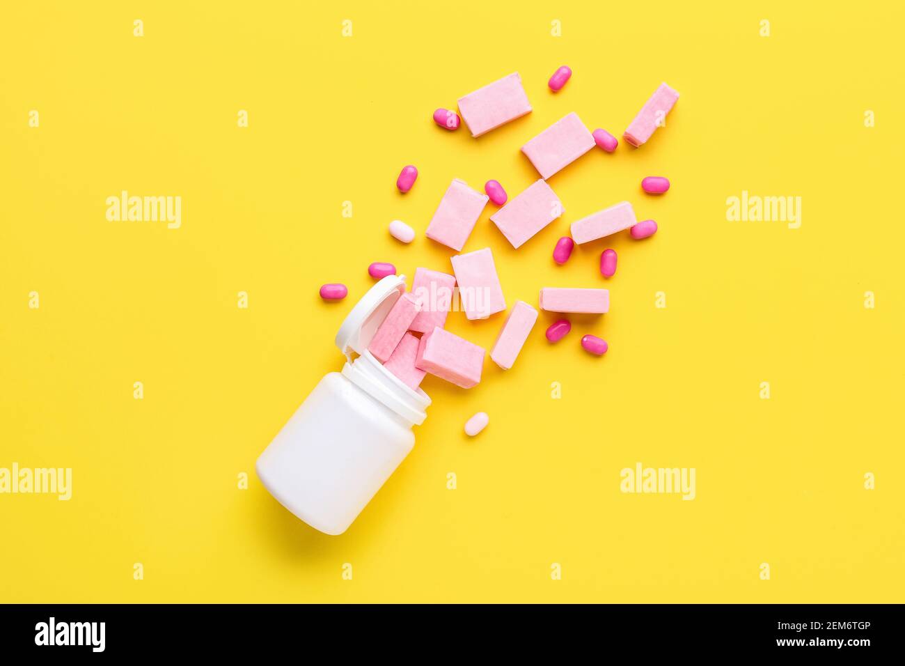 Container with chewing gums on color background Stock Photo - Alamy