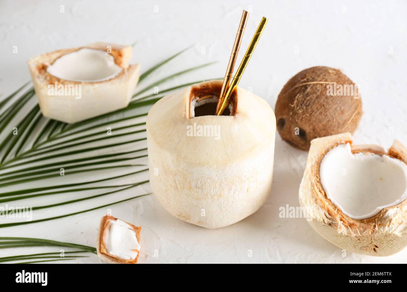 Fresh and ripe coconuts on light background Stock Photo - Alamy